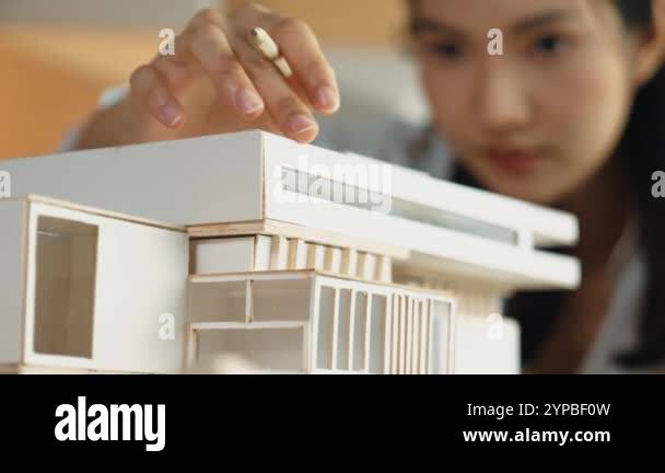 Closeup of skilled architect engineer hand pointing pencil at house ...