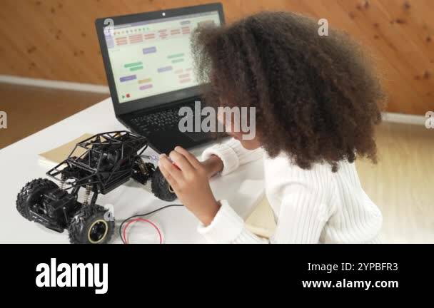 Smart african girl using screwdriver to repair or build a car model ...