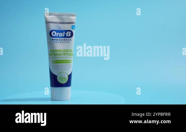 A tube of toothpaste with the brand name Oral B. The tube is blue and ...