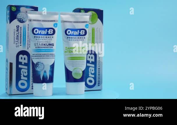 Two tubes of toothpaste, one blue, the other white. The tubes are ...