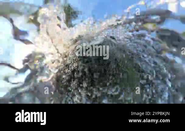 Dynamic underwater view capturing the swirl and splash of water with ...