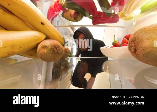 Zoom, A perspective from inside a refrigerator captures a man looking ...