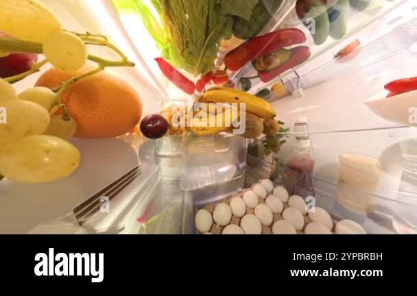 A 360-degree view inside a refrigerator showcases vibrant fruits ...