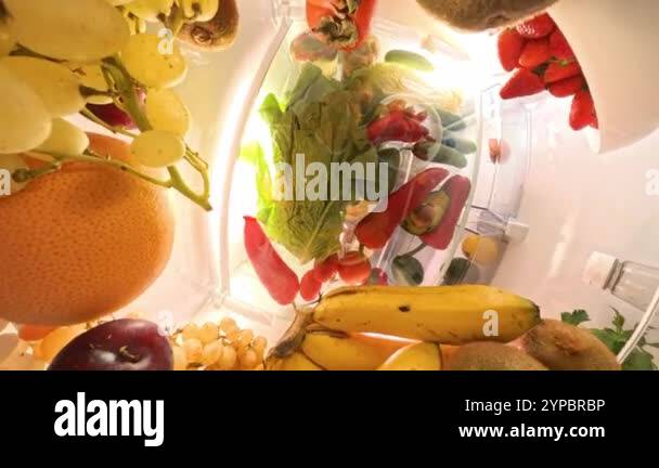 A close-up view inside a refrigerator shows the camera looking upward ...