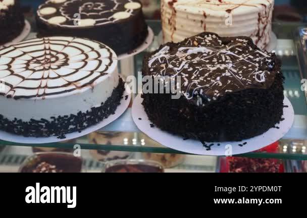 A tempting, visually stunning display of chocolate cakes with creative ...