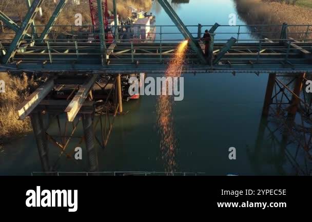 Above view, dolly move backwards on worker as cutting pillar of old ...