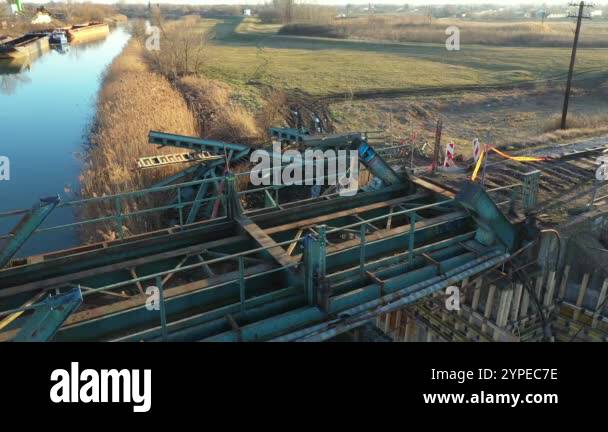 Above dolly move view on worker as cutting pillar of old railroad ...