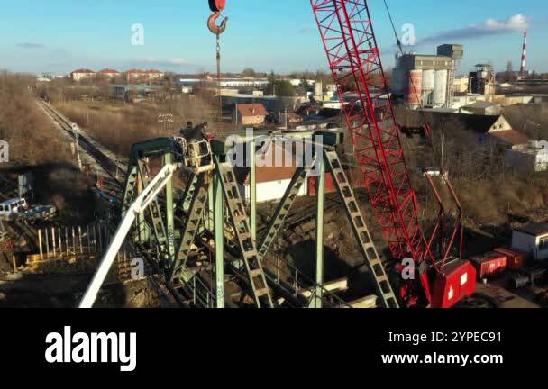 Above dolly move around view workers are cutting old railroad bridge ...