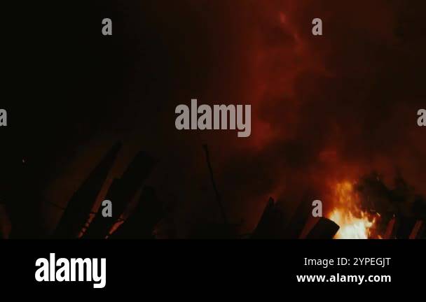 A powerful image capturing the intensity of fire against a dark sky ...