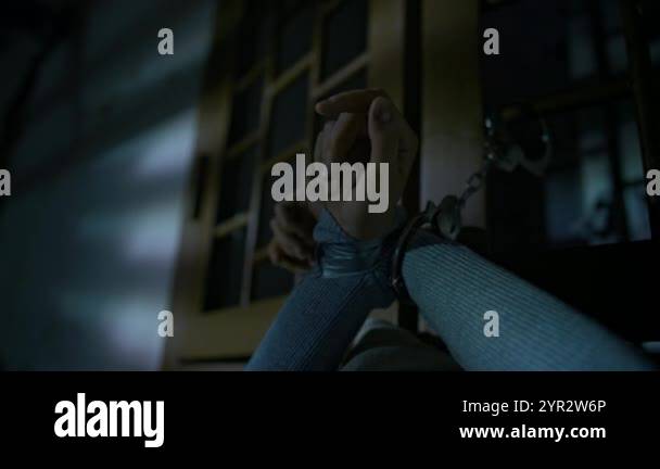 Handheld closeup of unrecognizable captive with sack on head being ...