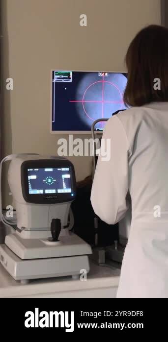 Doctor testing for eyes with special optical apparatus in modern clinic ...