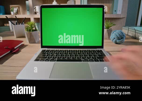Hands pressing keyboard chroma key laptop at office desk closeup ...