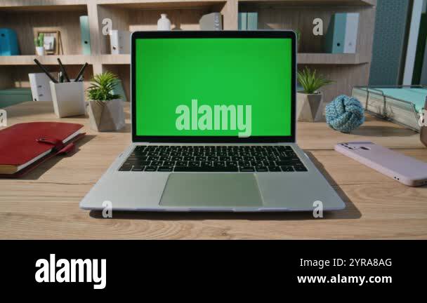 Office professional browsing greenscreen laptop at workspace closeup ...