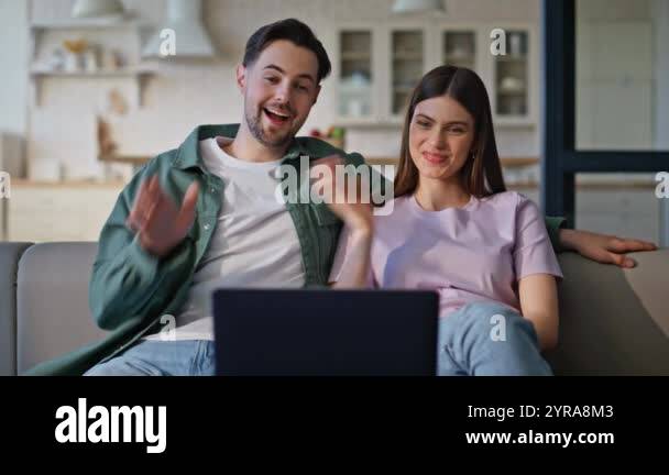 Spouses talking online meeting by laptop sitting home couch closeup ...