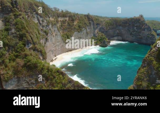 Hidden beach cove with steep cliffs and turquoise water, framed by ...
