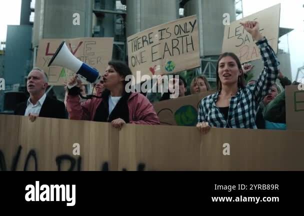 Nonconformist gen z activist woman shouting at a protest holding a ...