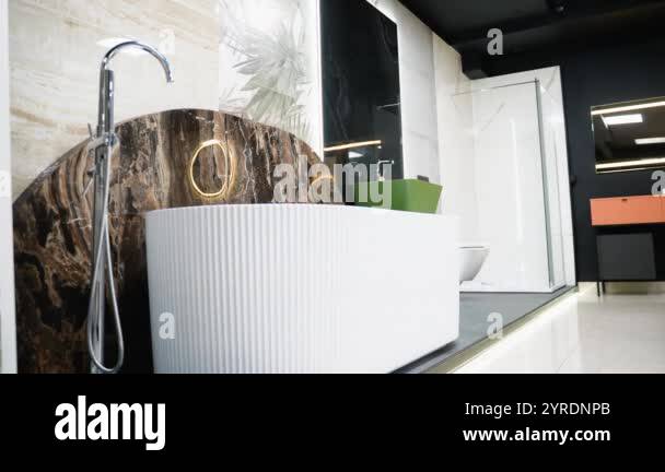 Stylish bathroom display with luxurious tiles, a unique freestanding ...