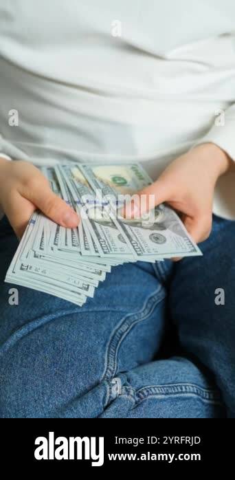 A stack of hundred-dollar bills in hands, the concept of accumulating ...