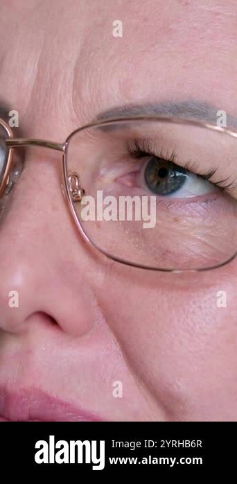 Depressed young blonde gal, glasses-wearing, expression etched with ...