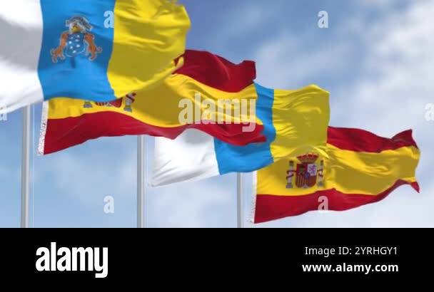 Canary Islands and spanish flag waving in the wind on a clear day ...