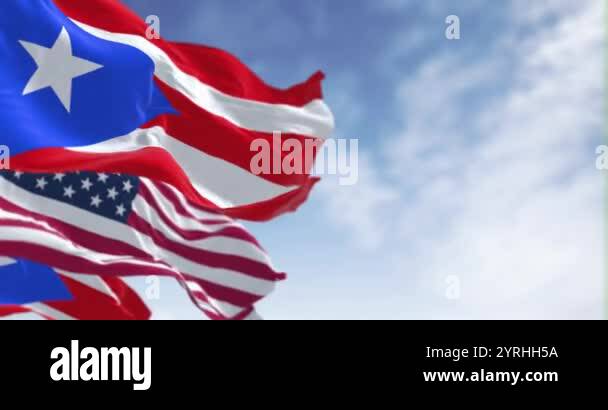 Flag of Puerto Rico waving with the United States flag on a clear day ...