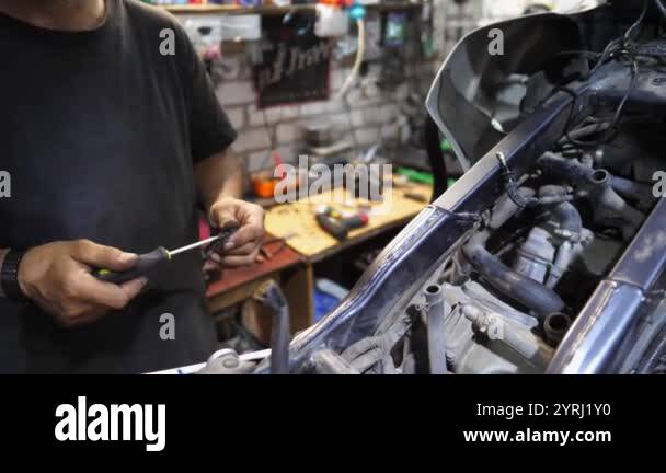 Male hands of mechanic repairing detail using tool at workplace. Arms ...