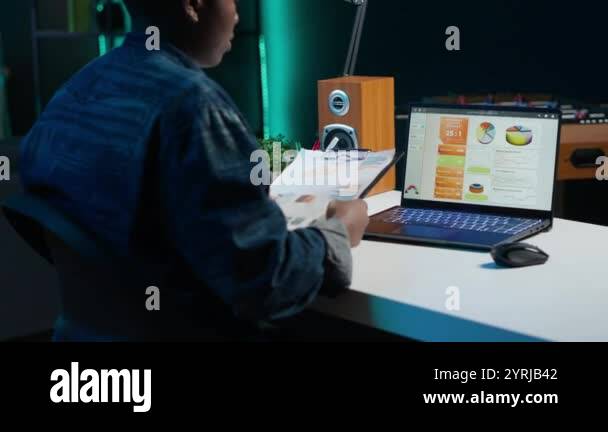 Accountant working from home taking notes on financial documents ...