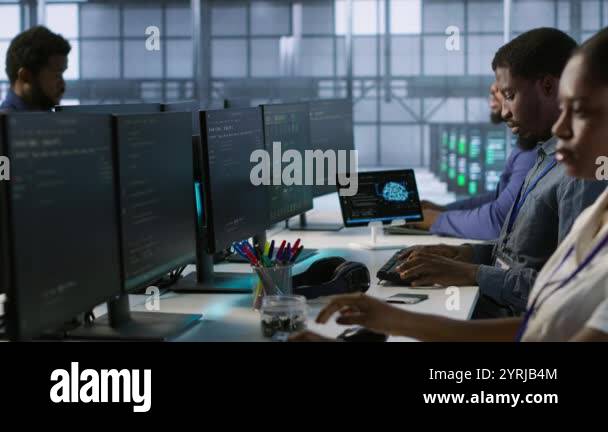 Computer scientists in data center implementing AI predictive maintenance systems. Server farm ...