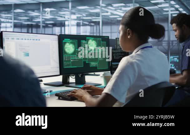 Woman seeing critical error on PC screen in data center, requesting help from cybersecurity team ...