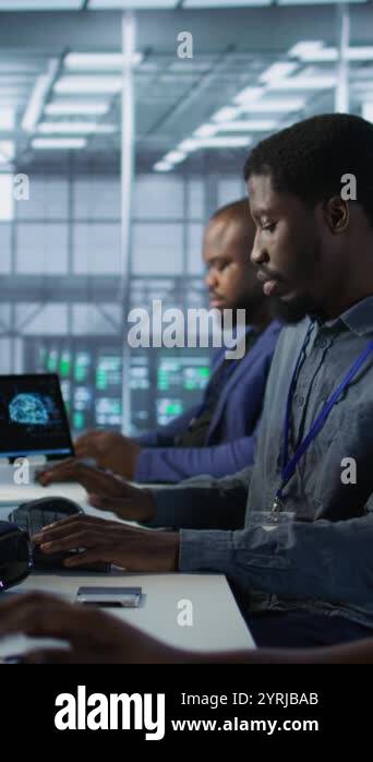 Vertical video Team of engineers in data center developing and maintaining disaster recovery ...