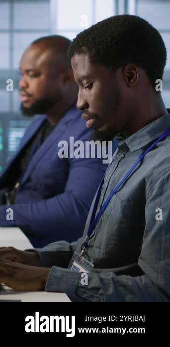 Vertical video System administrators in data center implementing AI predictive maintenance ...