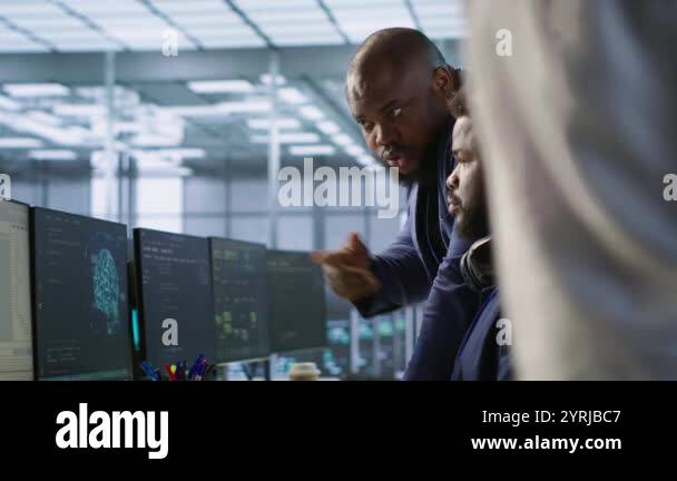 Data center manager helps intern implement AI predictive maintenance systems. Server farm ...