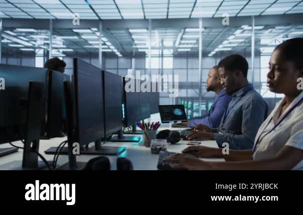 Computer scientists in data center implementing AI predictive maintenance systems. Server farm ...