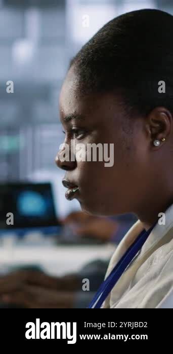 Vertical video Close up of programmer in data center implementing AI predictive maintenance ...