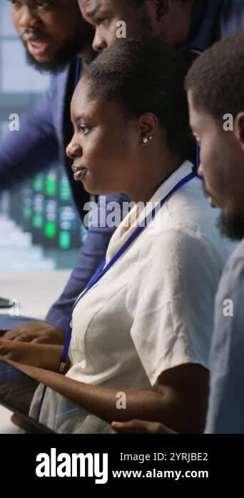 Vertical video Team of data center technicians maintaining company network infrastructure by ...