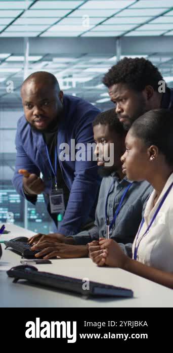 Vertical video Coworkers in data center doing brainstorming, implementing AI predictive ...
