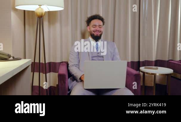 Cheerful professional man, dressed in sharp formal attire, smiles ...