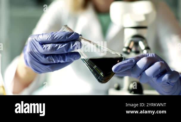 A scientist diligently working in a laboratory, using a pipette to ...