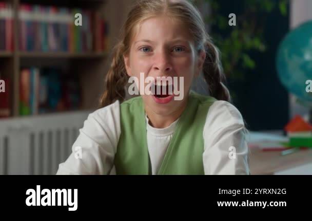 Mad furious Caucasian little girl school child kid schoolgirl angry naughty teenage learner ...