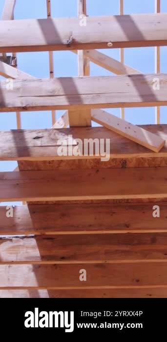 Wooden beams open roof structure with progress large construction site ...