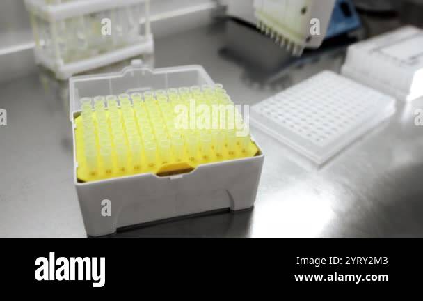 Close-up of putting a replacement pipette tip from a pipette box onto a ...