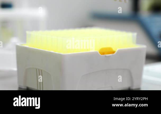 Close-up of putting a replacement pipette tip from a pipette box onto a ...