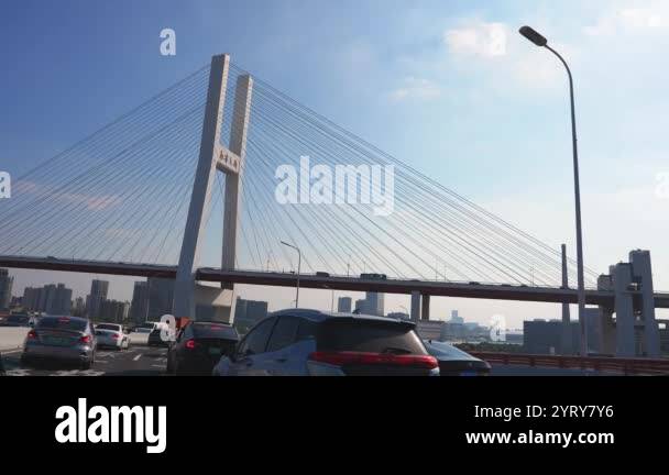Nanpu Bridge in Shanghai is busy with traffic. The skyline features ...