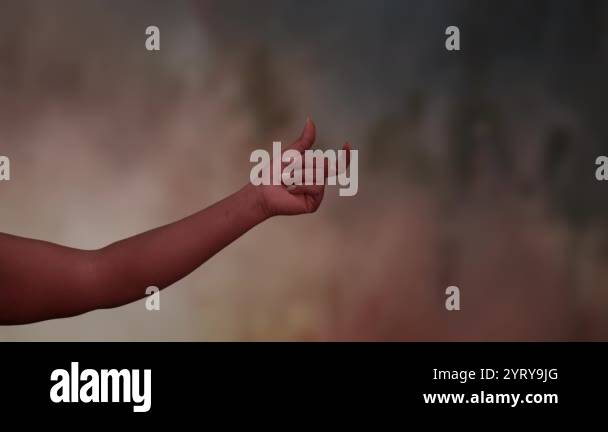 Close up shot of human hand raising, with finger snapping gesture. The ...