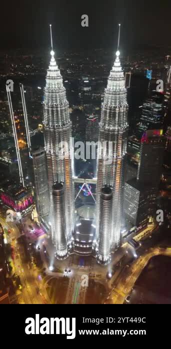 Night view of Kuala Lumpur from a drone, fly-around of the Petronas ...