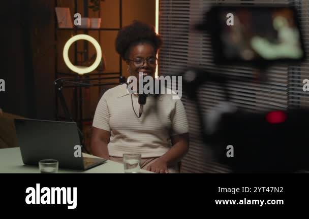 Backstage from podcasting with young smiling African American woman ...