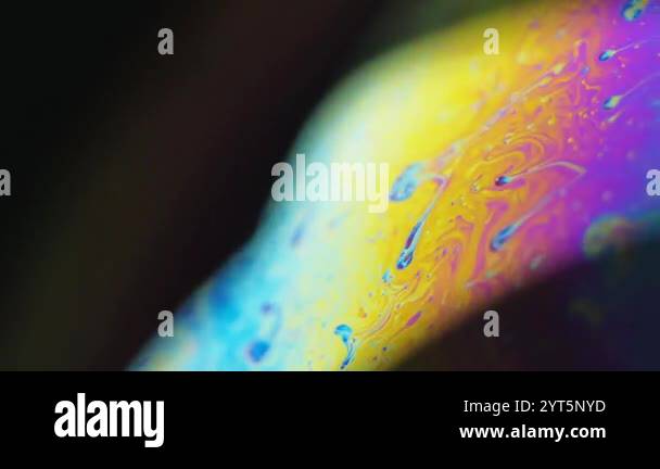 Gasoline fluid. Psychedelic spectrum. Defocused yellow pink blue color ...