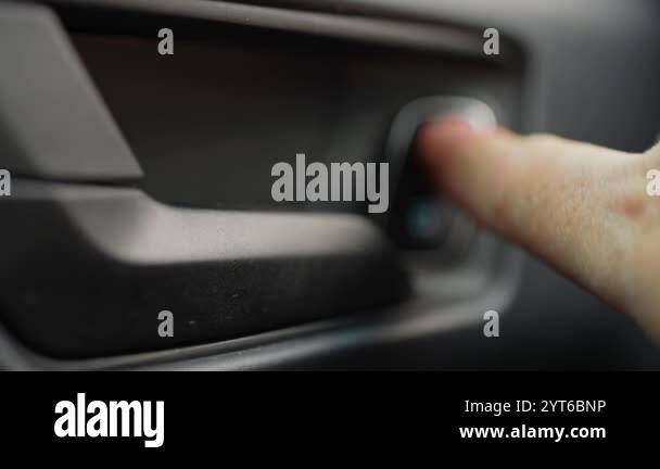 Driver press unlock button to unlocking the vehicle door. Person push ...