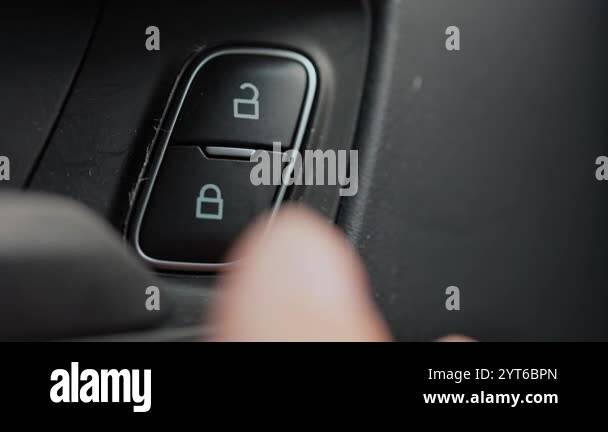Driver press lock button for locking the vehicle door. Person push car ...