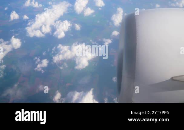 Clouds and Landscape Viewed From Airplane Window During Flight Over ...